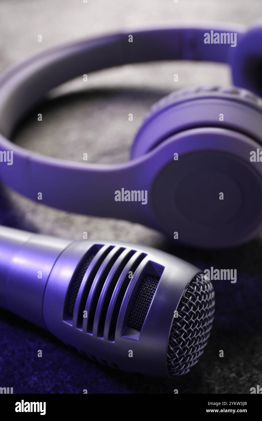 Microphone and headphones on grey textured table, closeup. Sound ...