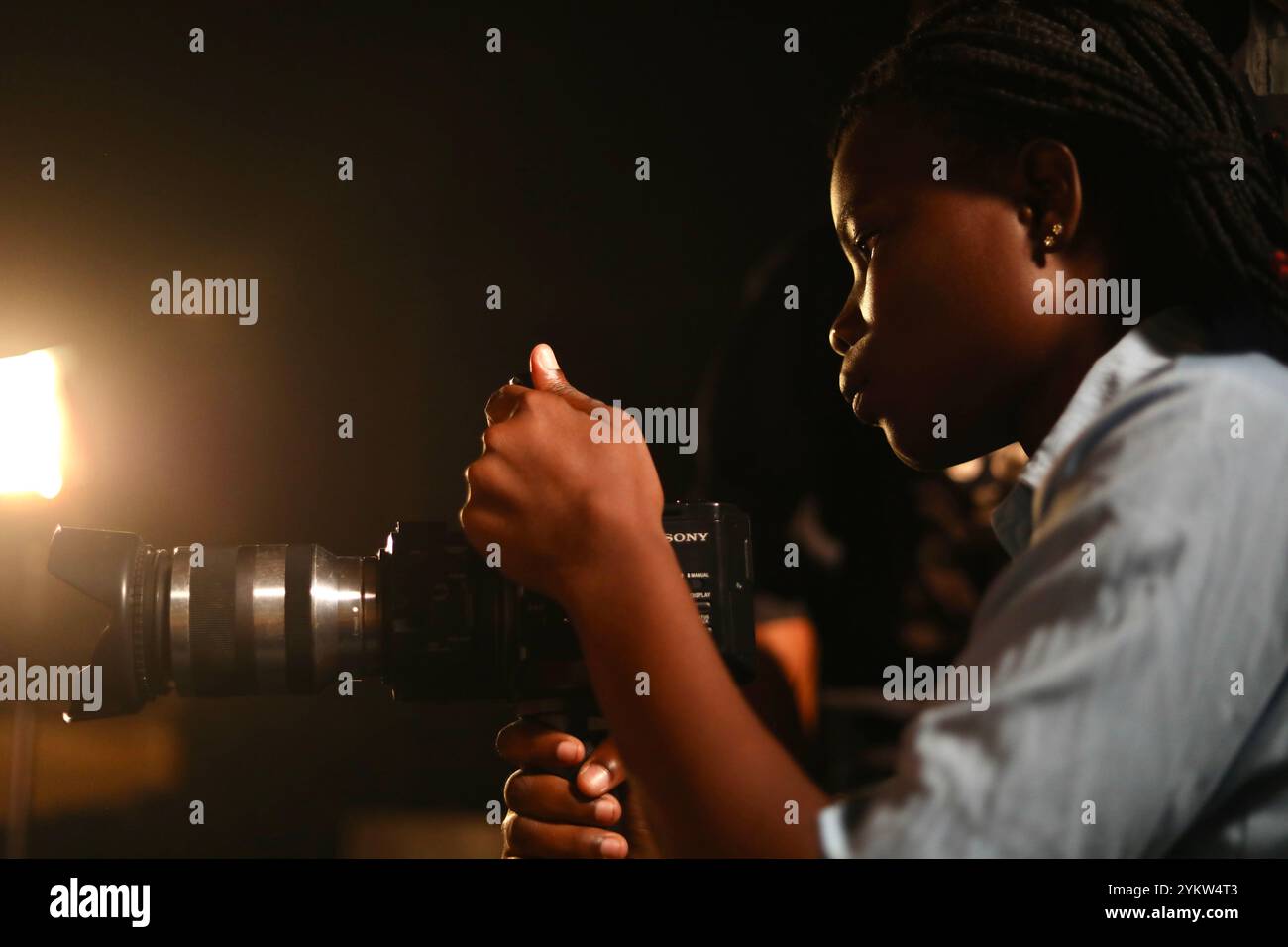 A student cinematographer films a scene for a short film on the set of ...
