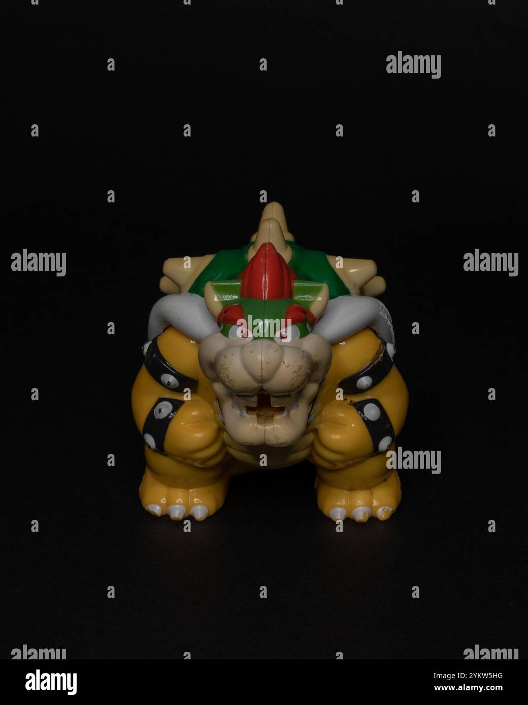 Dragon-like plastic toy on a black background. King Bowser is a ...