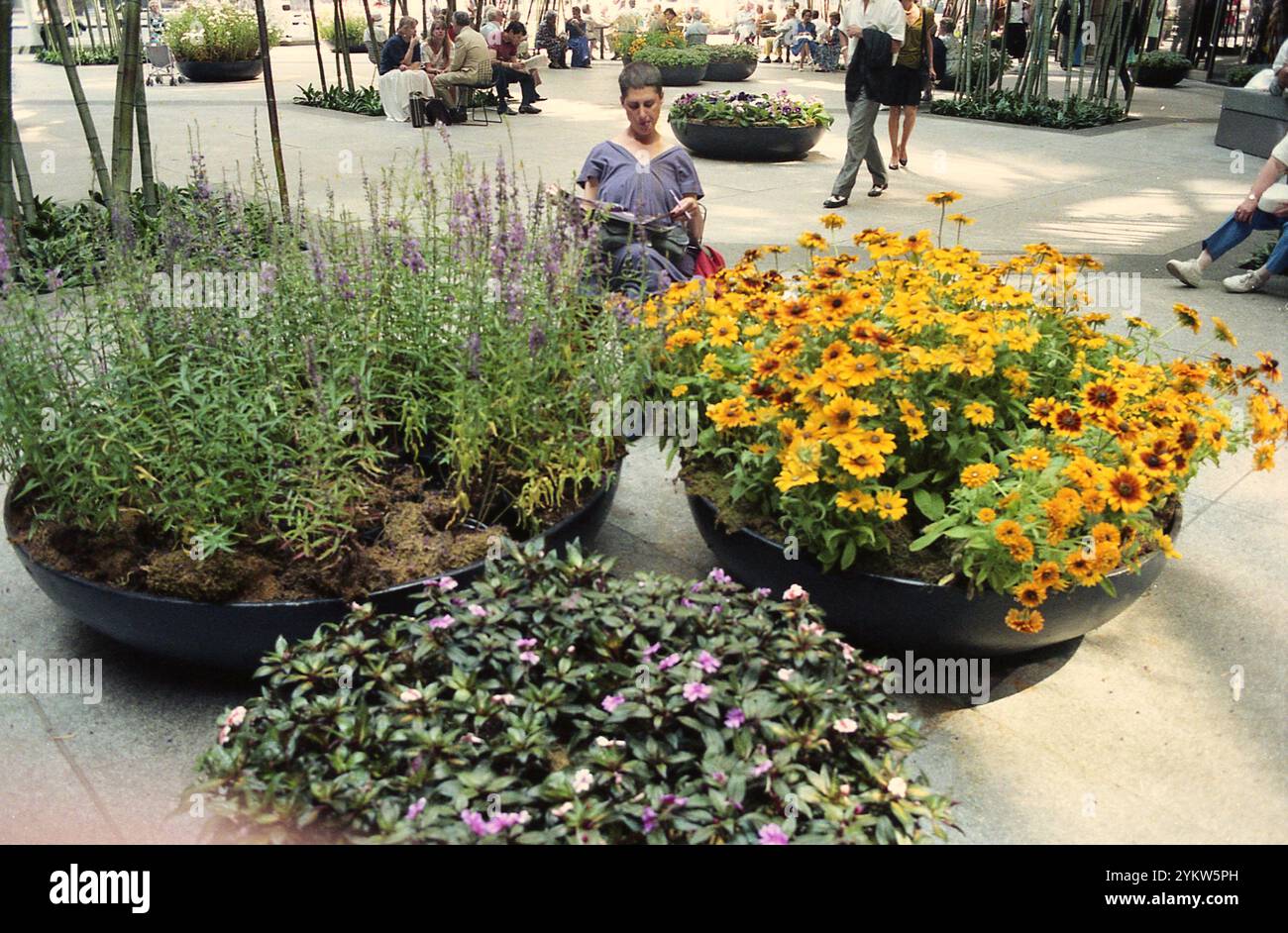 New York City, NY, USA, 1982. People enjoying the atrium at 590 Madison ...