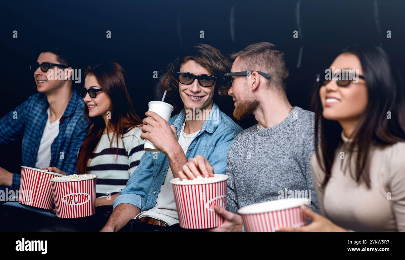 Happy friends on 3D movie premiere in cinema Stock Photo - Alamy