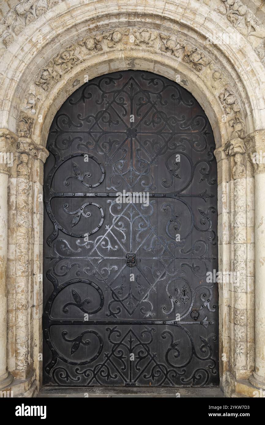 Wooden door decorated with wrought-iron fittings, magnificent entrance ...