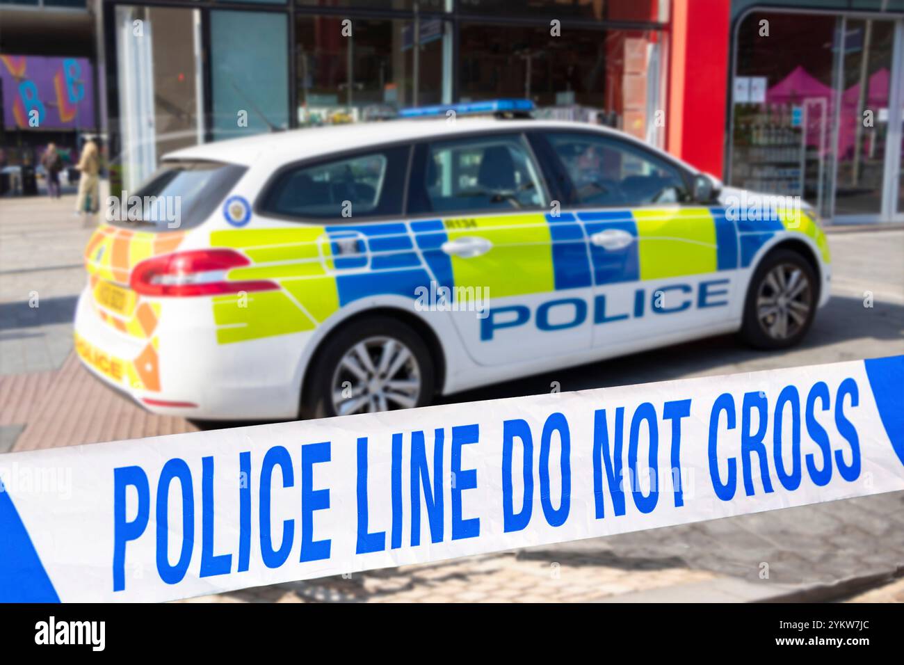 Blue and white police line do not cross crime scene tape in focus with ...