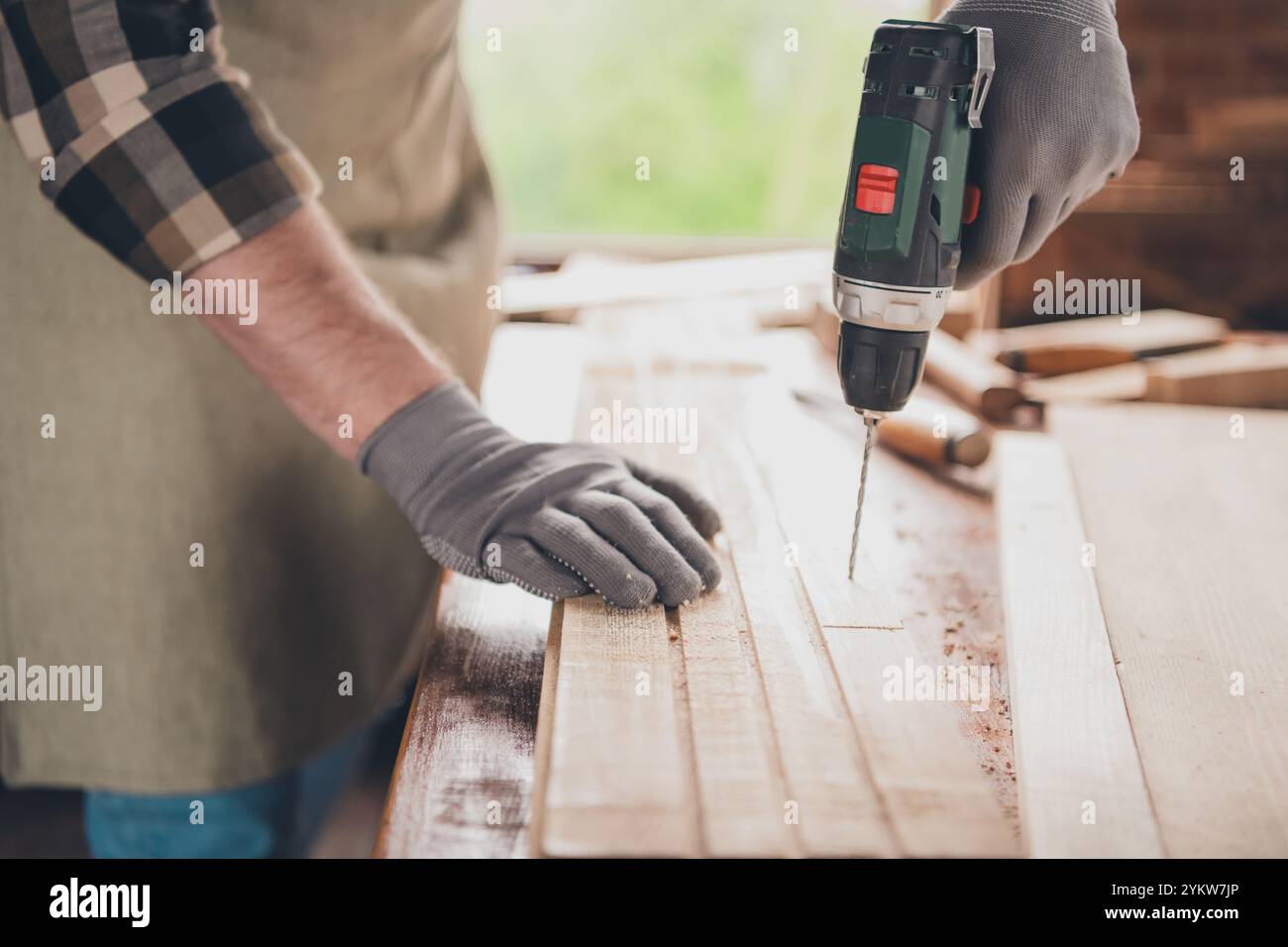 Closeup photo of professional joiner working repairing wooden plank ...