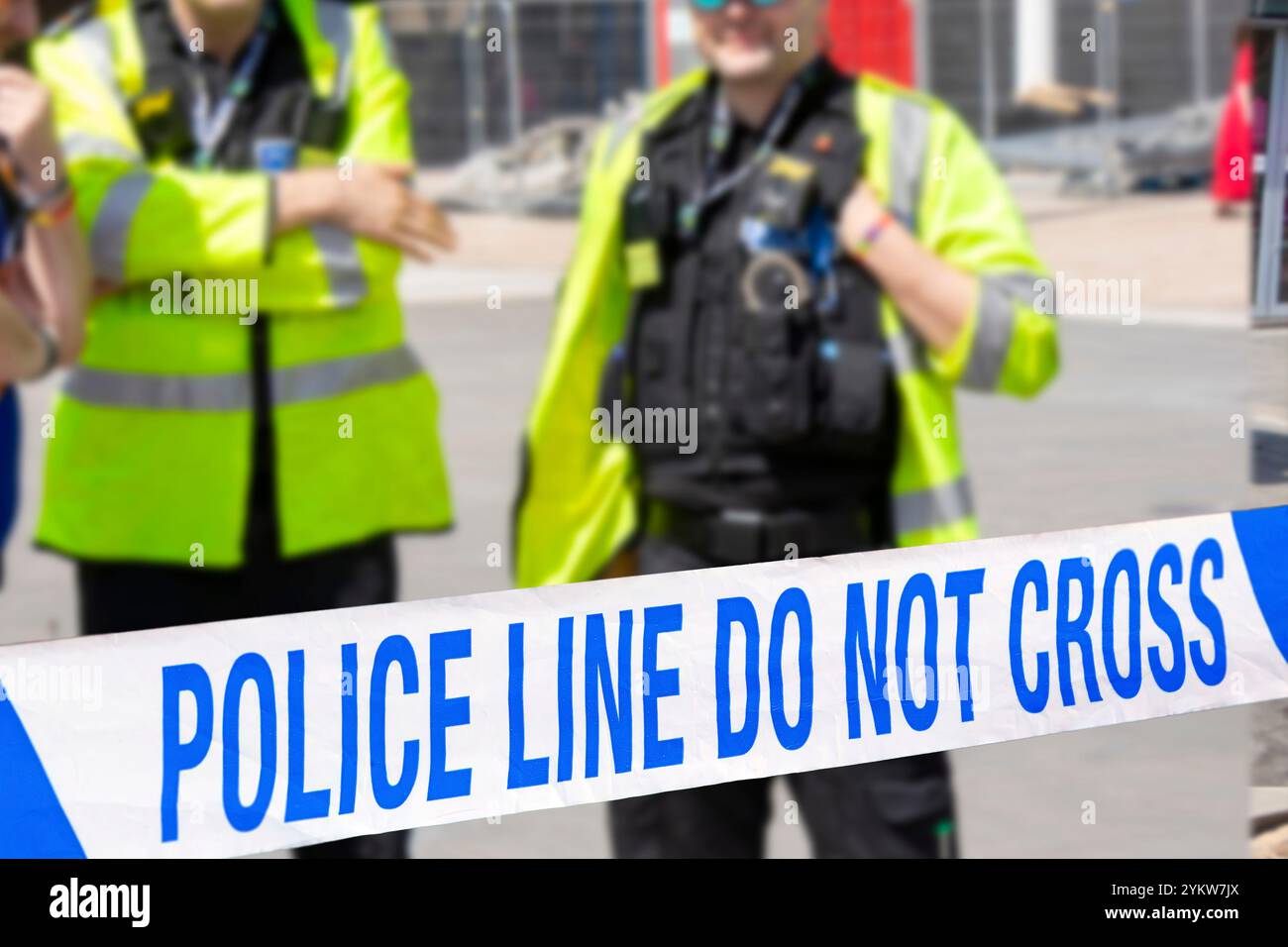 Blue and white police line do not cross crime scene tape in focus with ...