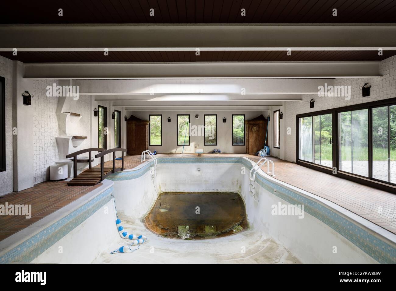 An empty indoor swimming pool inside a mansion. This house has since ...