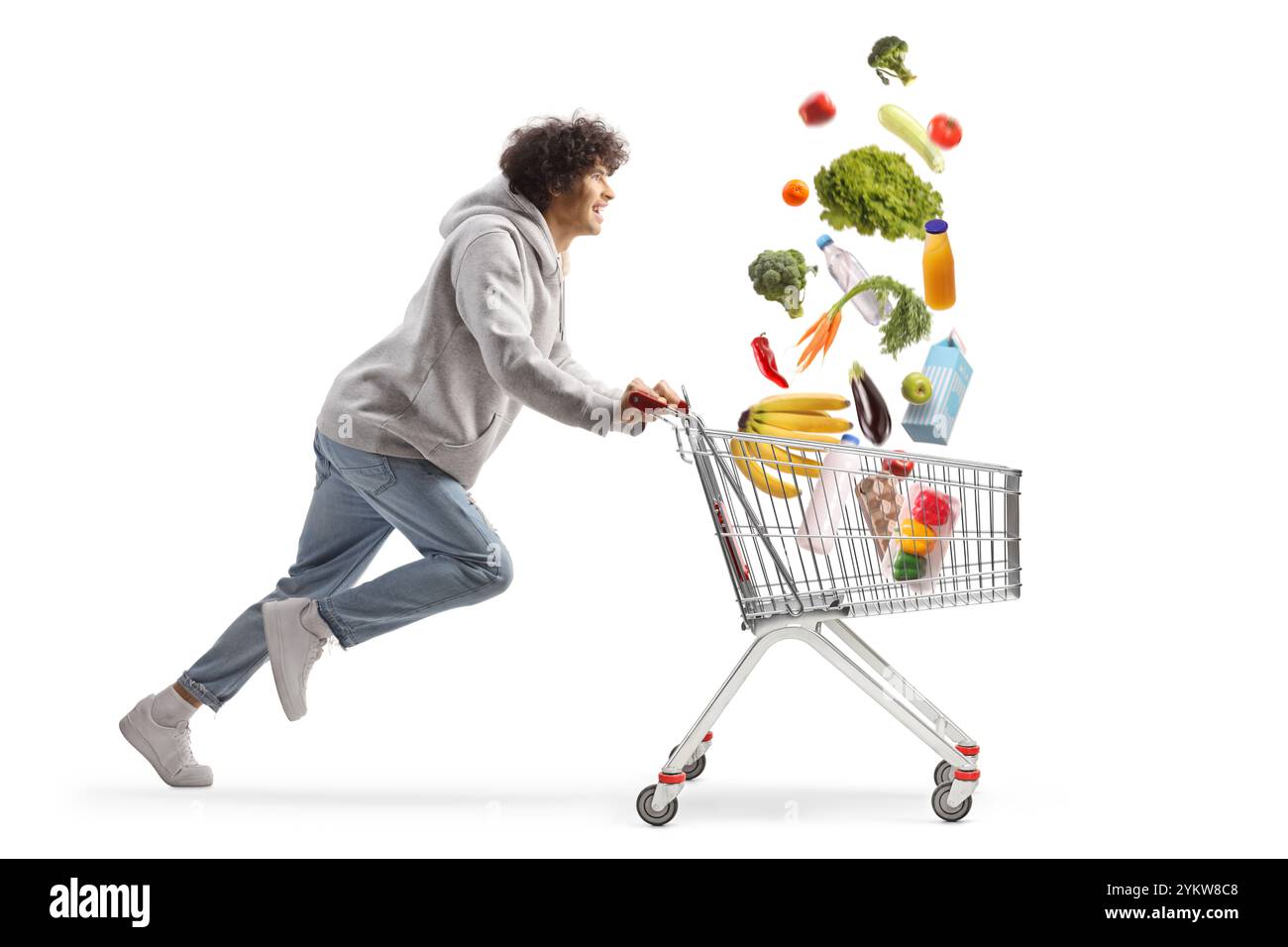 Young man running with groceries falling in a shopping cart isolated on ...