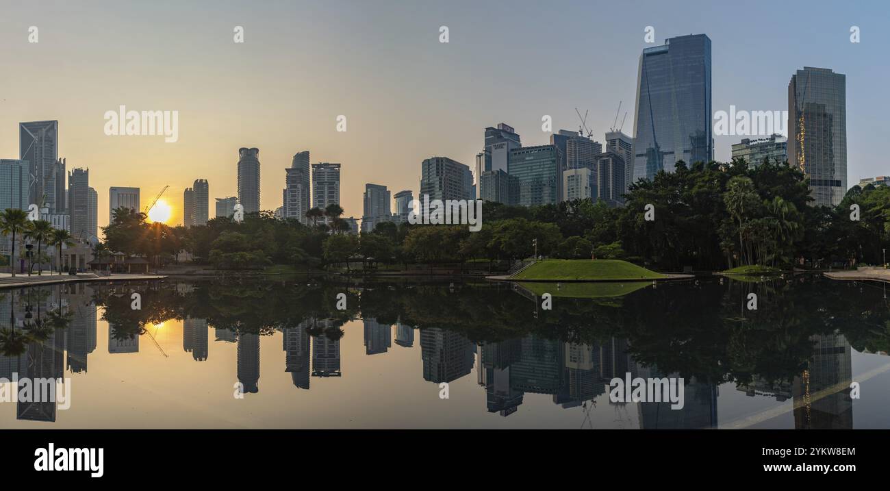 A picture of the KLCC Park at dawn, with the high rises of Kuala Lumpur ...