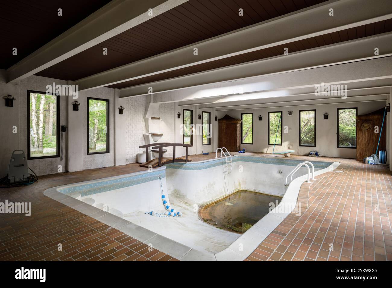 An empty indoor swimming pool inside a mansion. This house has since ...