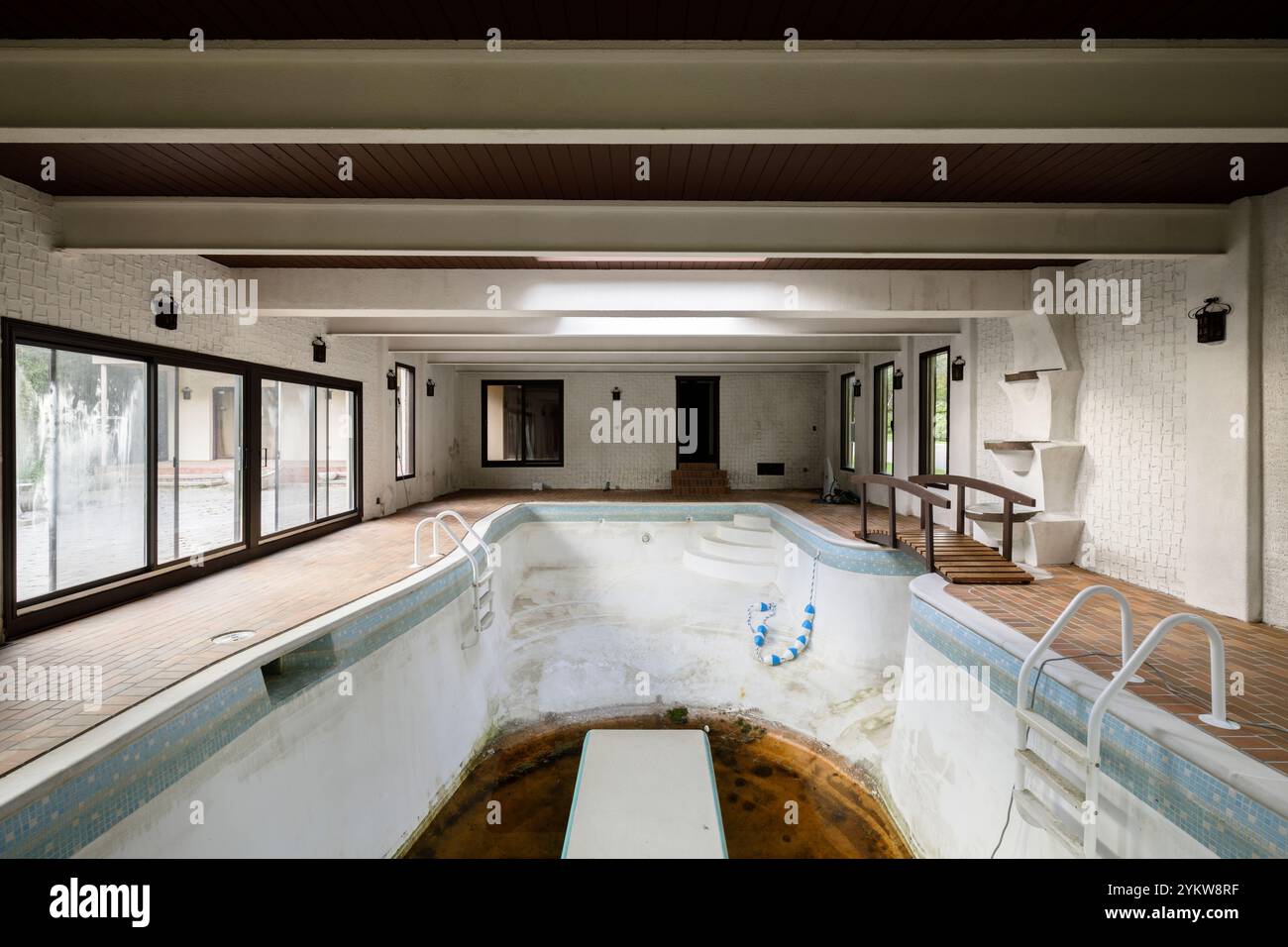 An empty indoor swimming pool inside a mansion. This house has since ...