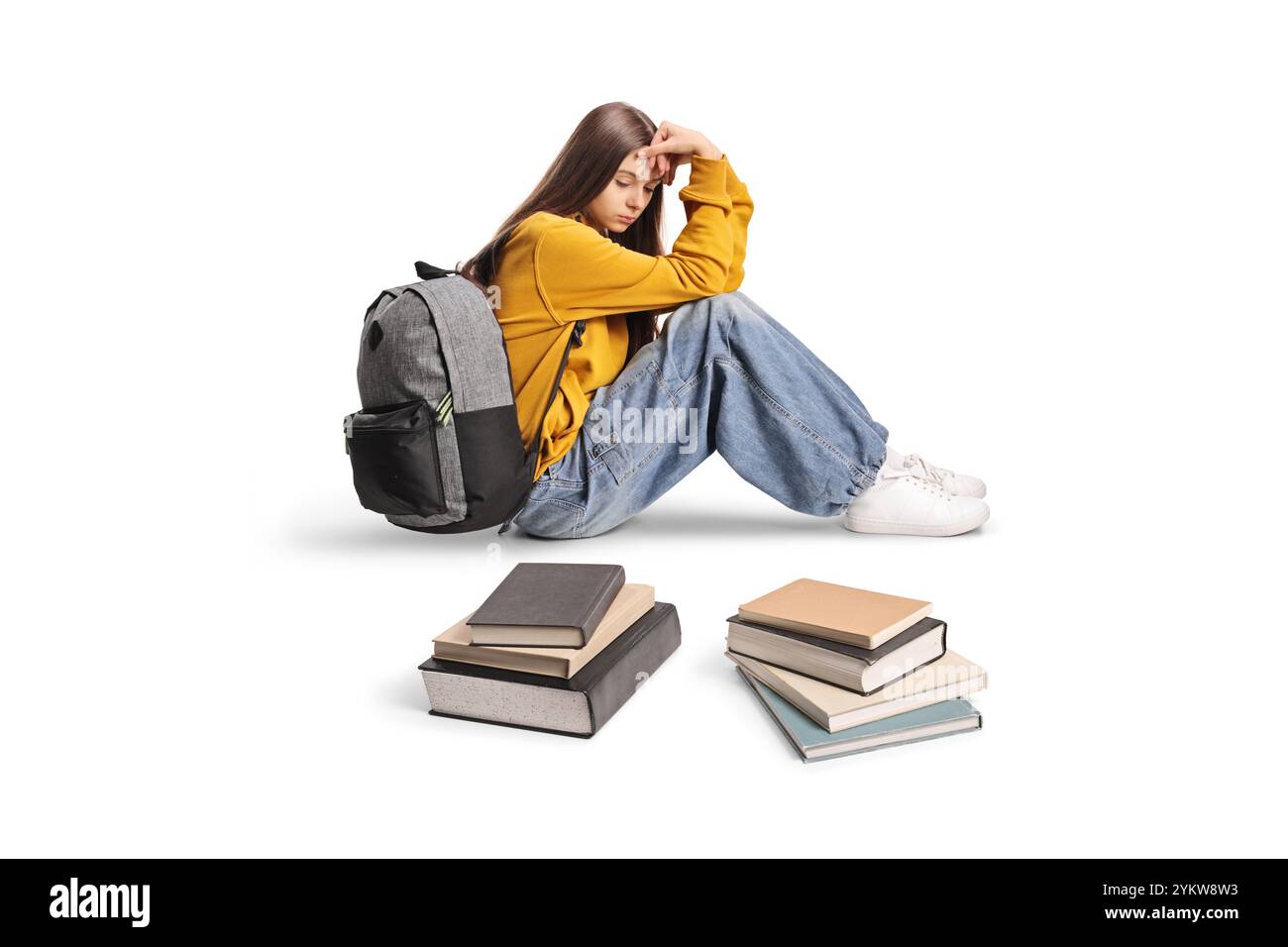 Sad female student sitting on the ground and looking at piles of books ...