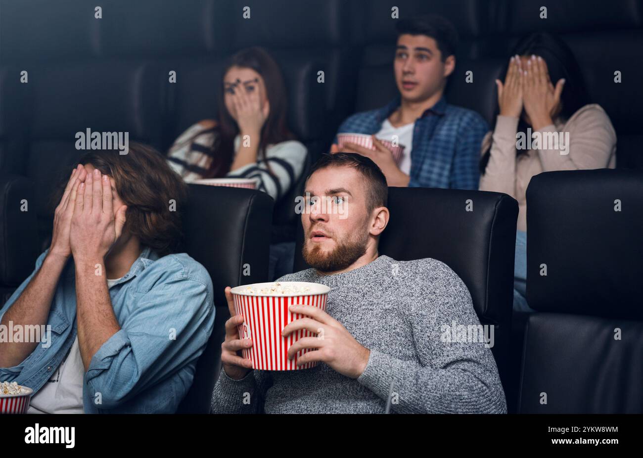 Frightened spectators on scary movie premier in cinema Stock Photo - Alamy