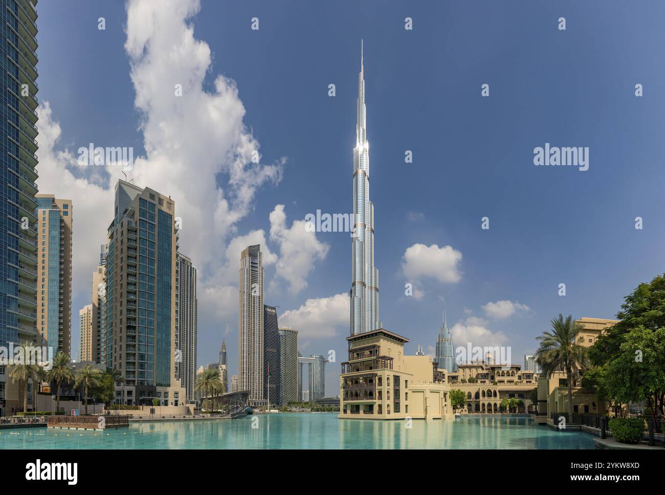 A picture of the Burj Khalifa towering the nearby Downtown Dubai ...