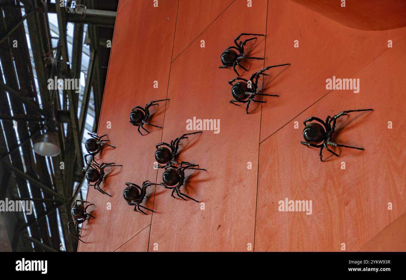 A picture of an art installation with black spiders on display at the ...