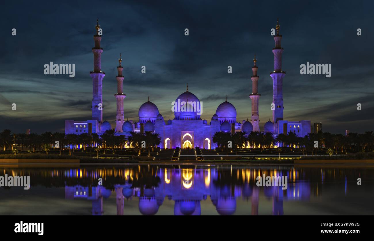 A picture of the illuminated Sheikh Zayed Grand Mosque reflected on the ...