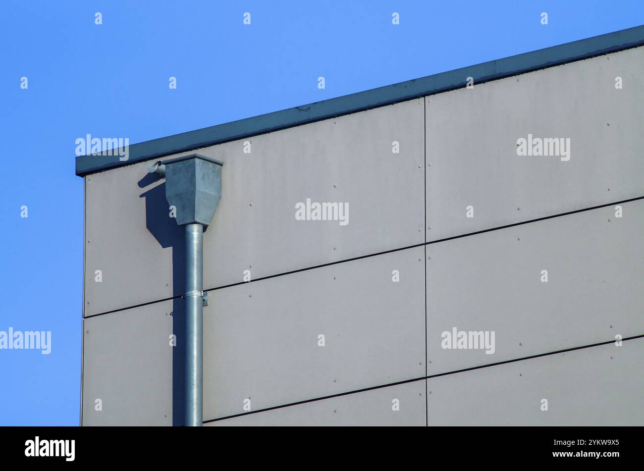 Metal downspout efficiently channeling rainwater from rooftop into ...