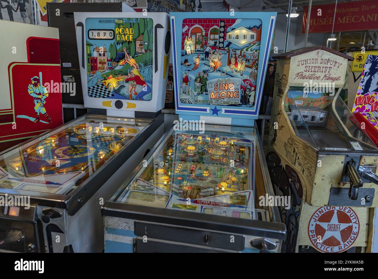 A picture of some retro arcade games, including two pinball machines ...
