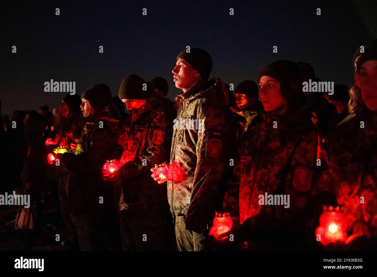 Ukrainian servicemen hold candles during a memorial ceremony marking ...