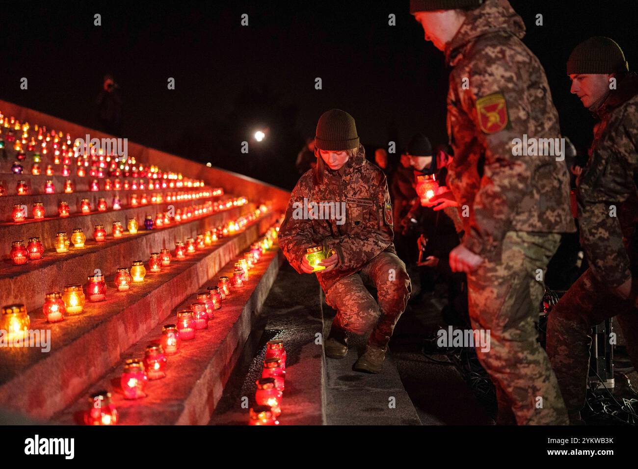 Ukrainian servicemen hold candles during a memorial ceremony marking ...