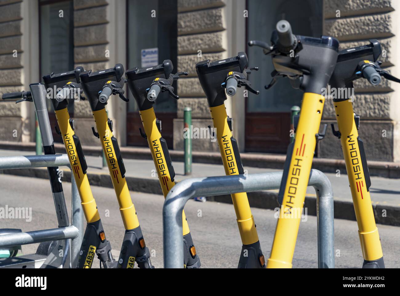 A picture of multiple yellow Whoosh electric scooters on a street Stock ...