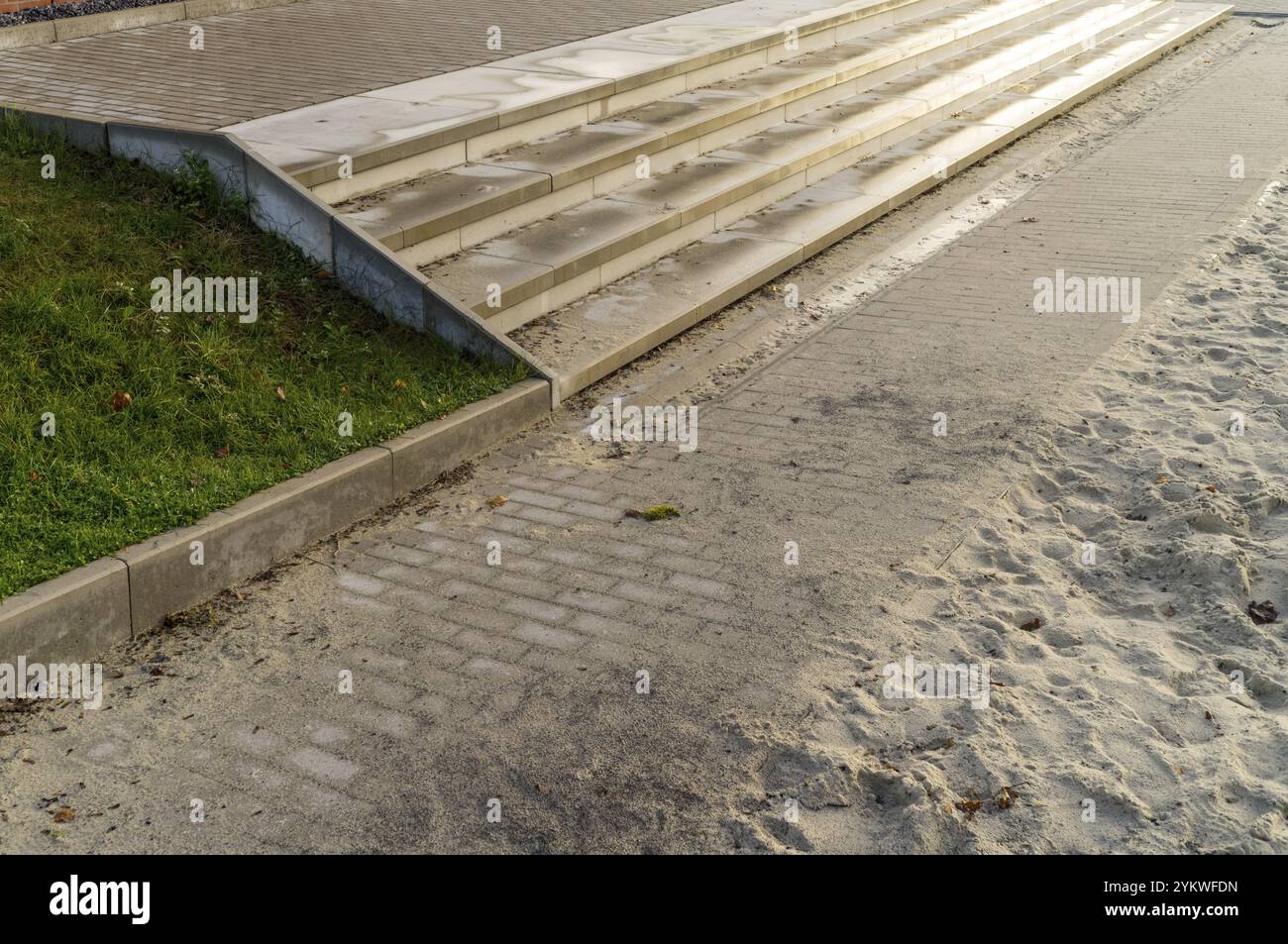 Concrete stairs leading to a sandy beach covered with sand Stock Photo ...