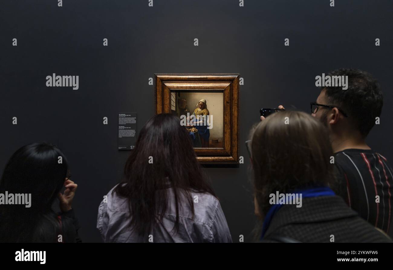A picture of people watching The Milkmaid painting, by Johannes Vermeer ...