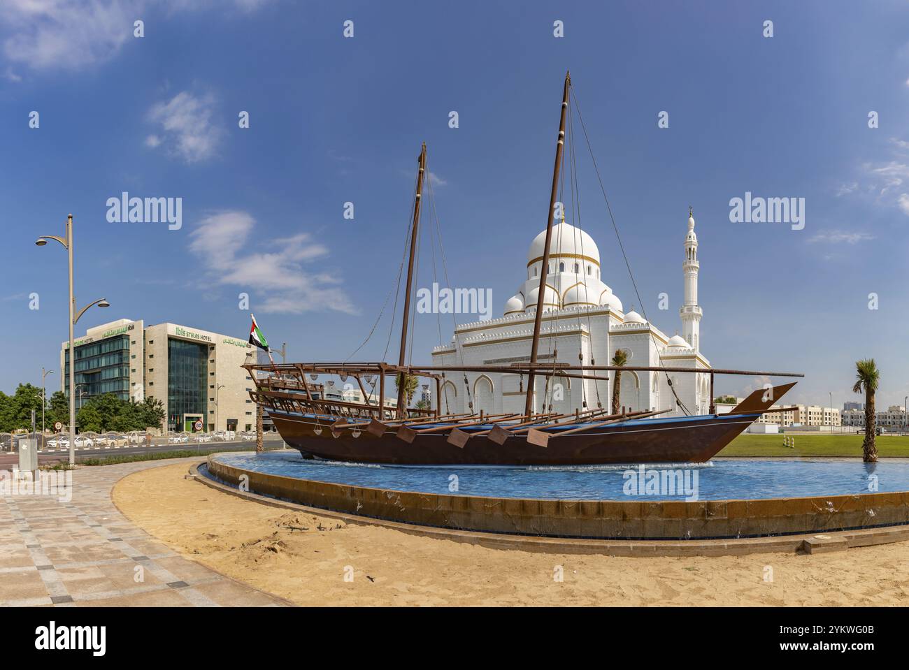 A picture of a dhow boat next to the Sheikh Rashid Bin Mohammed mosque ...