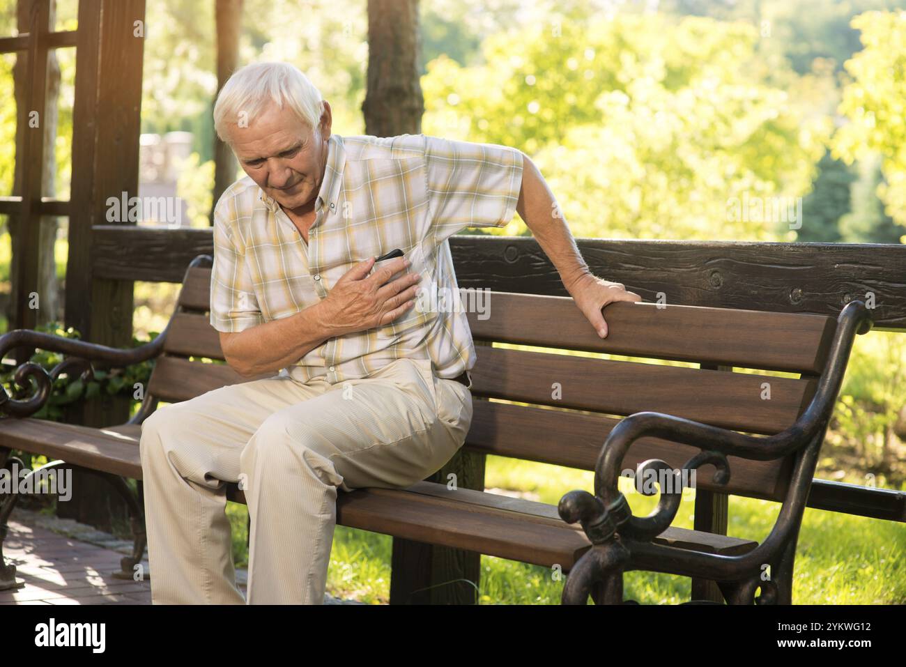 Senior guy has heartache. Elderly man on park bench. Too much stress ...