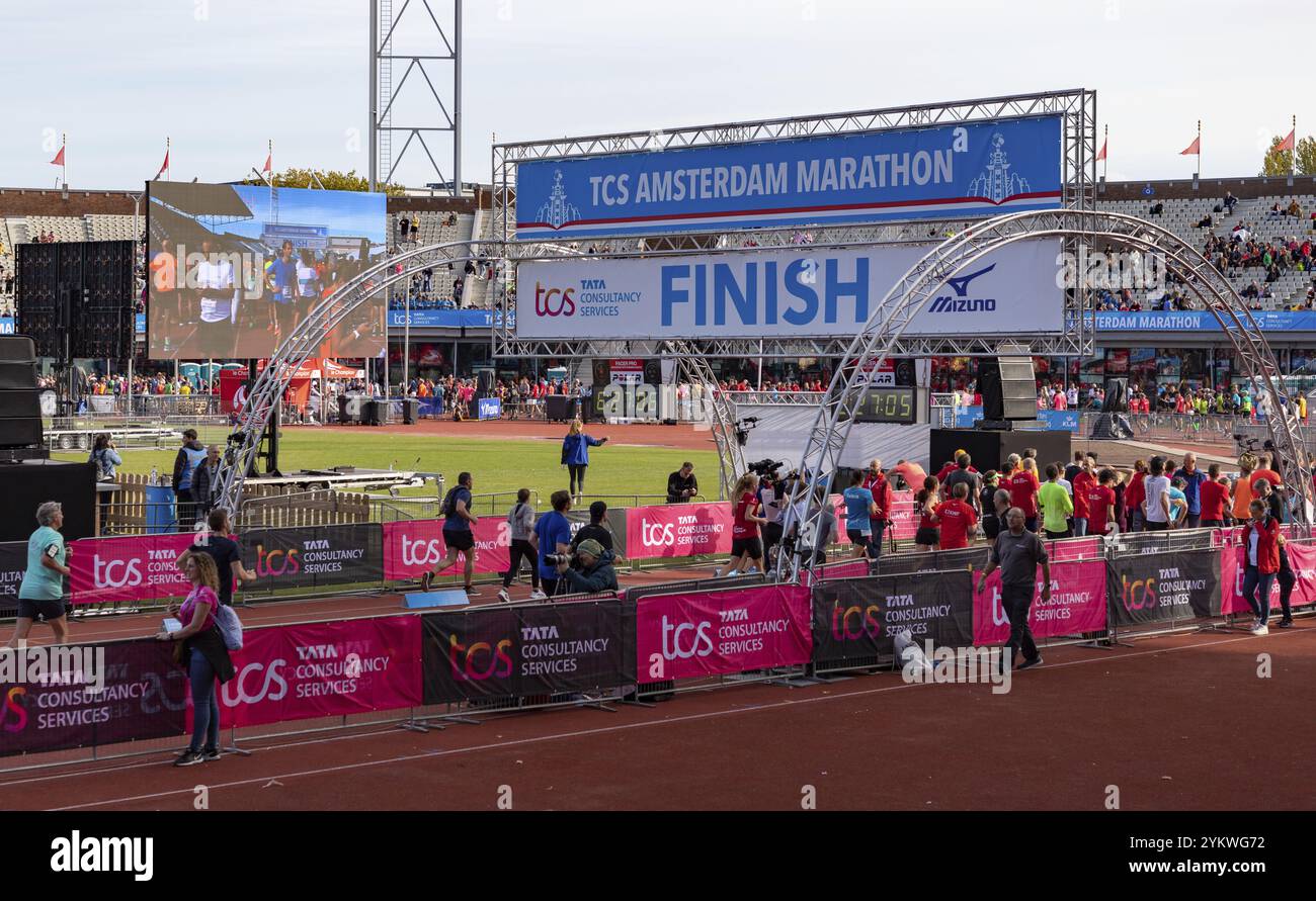 A picture of multiple runners on the finish line of the Amsterdam ...