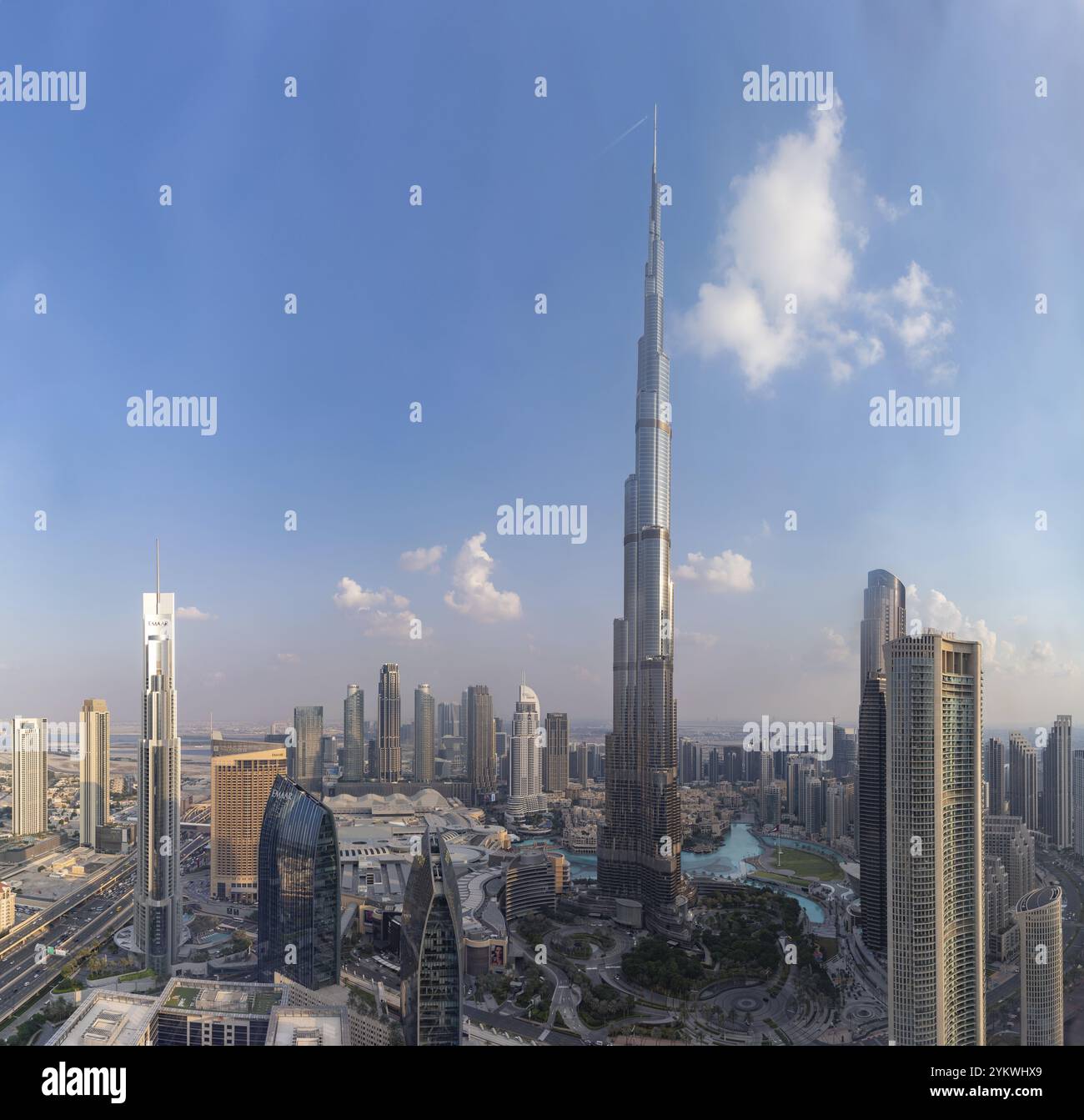 A picture of the Burj Khalifa towering the buildings of the nearby ...