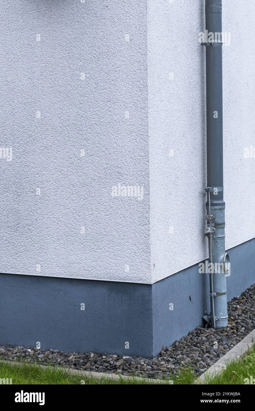 Metal downspout attached to the corner of a modern building with ...