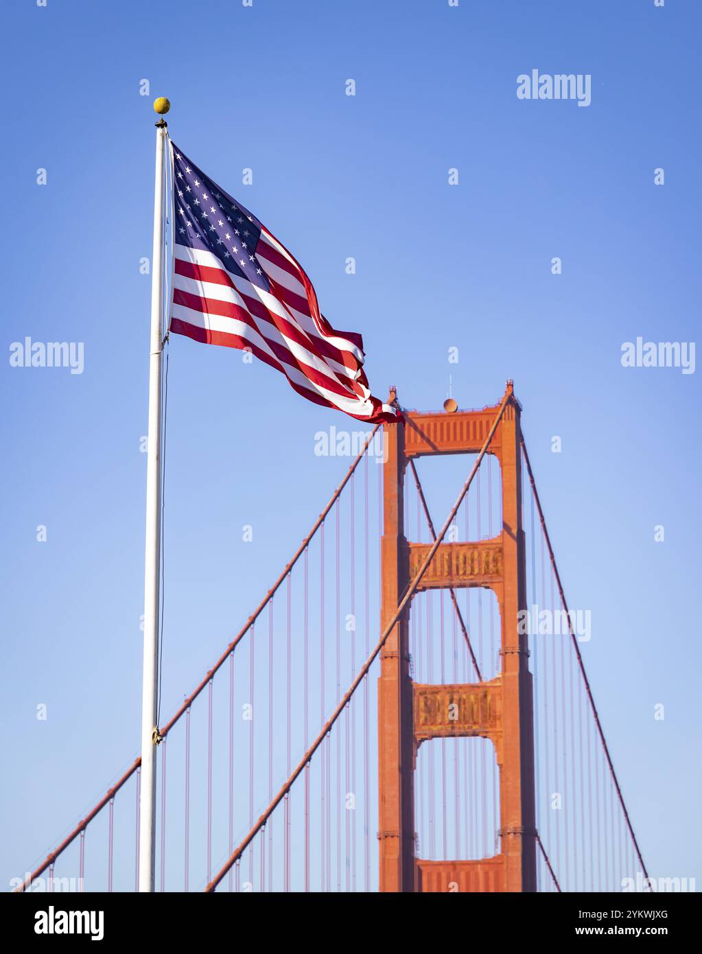 A picture of an American flag next to the Golden Gate Bridge Tower ...