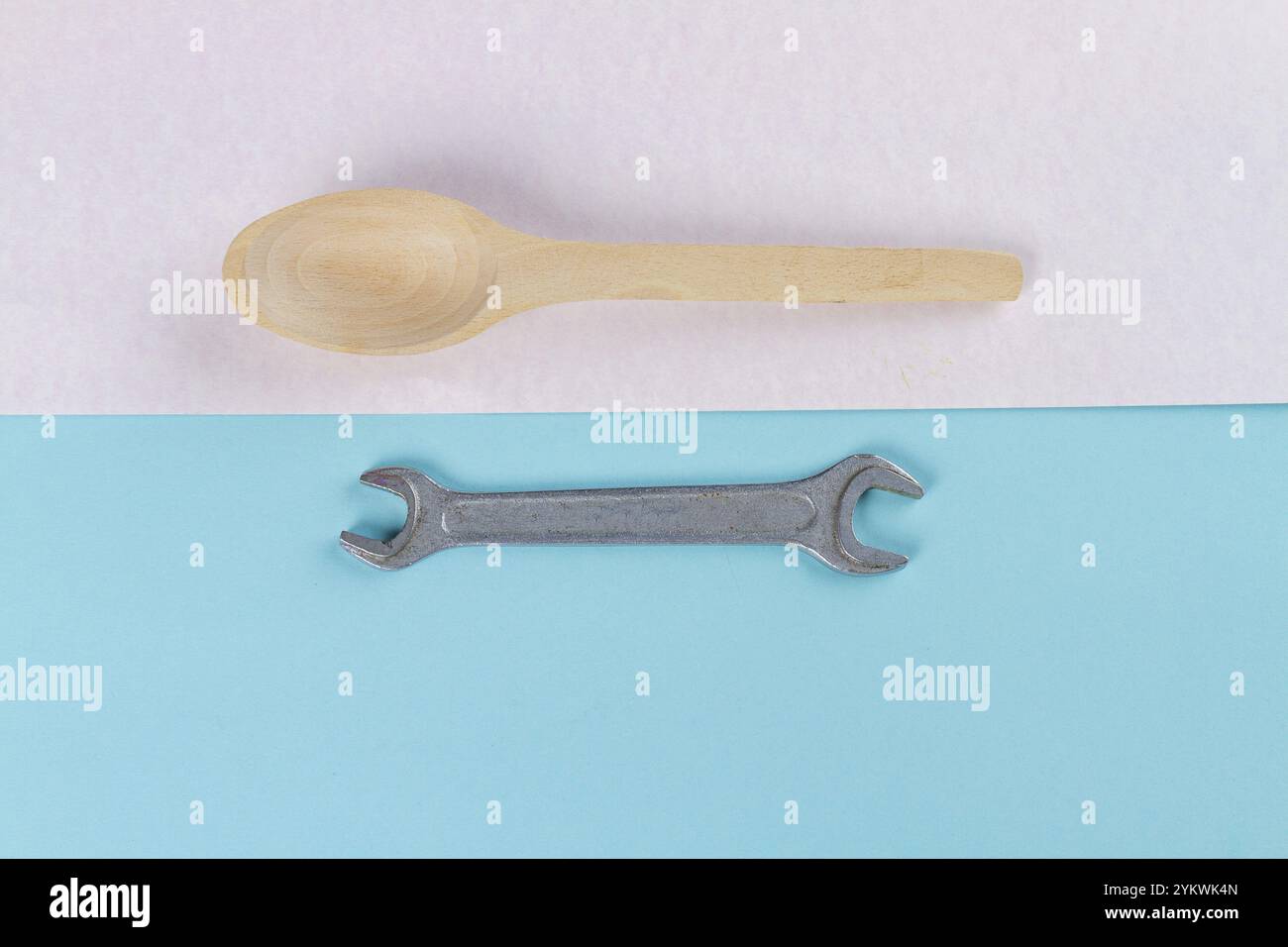 Top view wooden rustic spoon and metallic wrench. Concept of separation ...