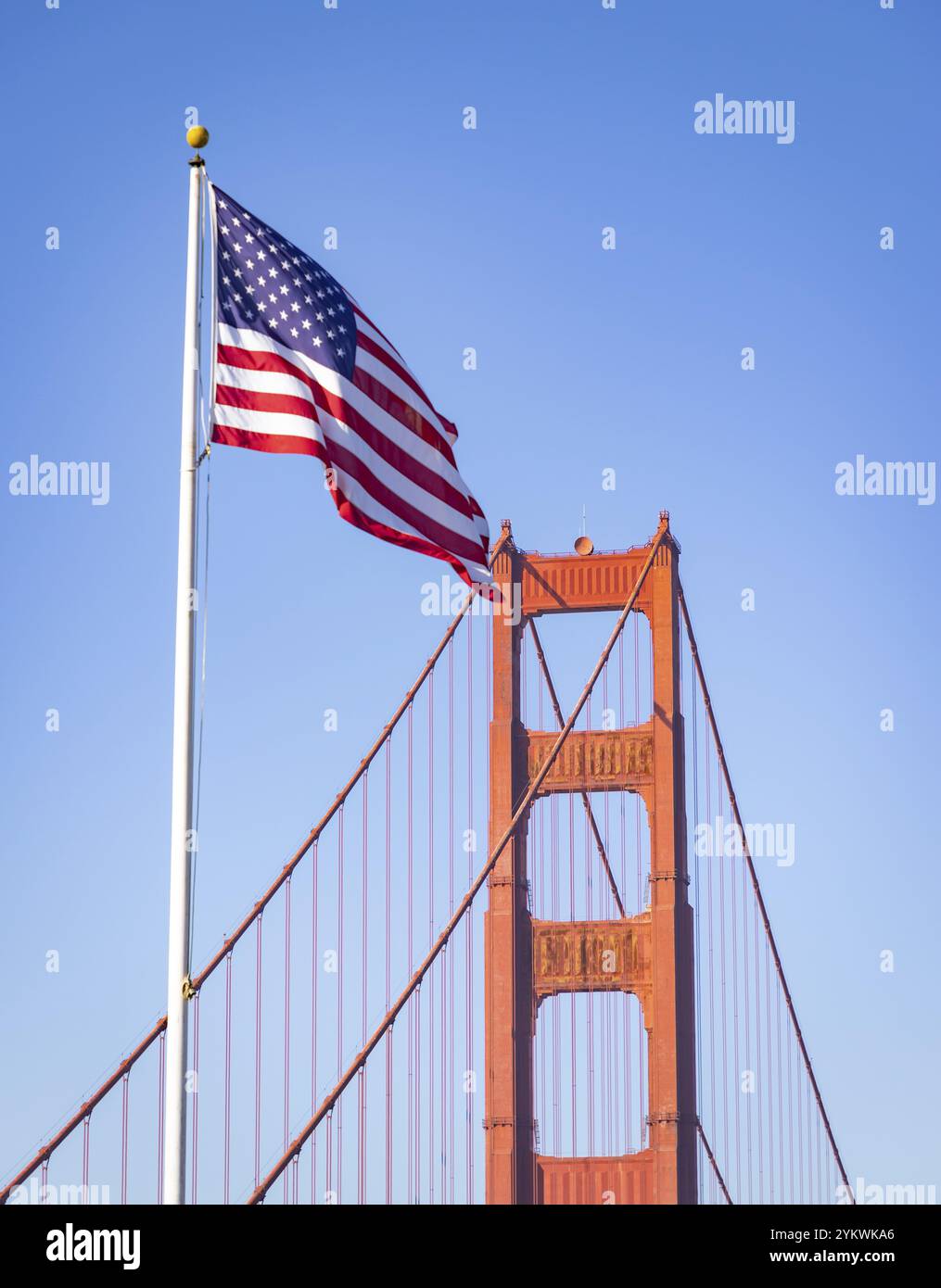 A picture of an American flag next to the Golden Gate Bridge Tower ...