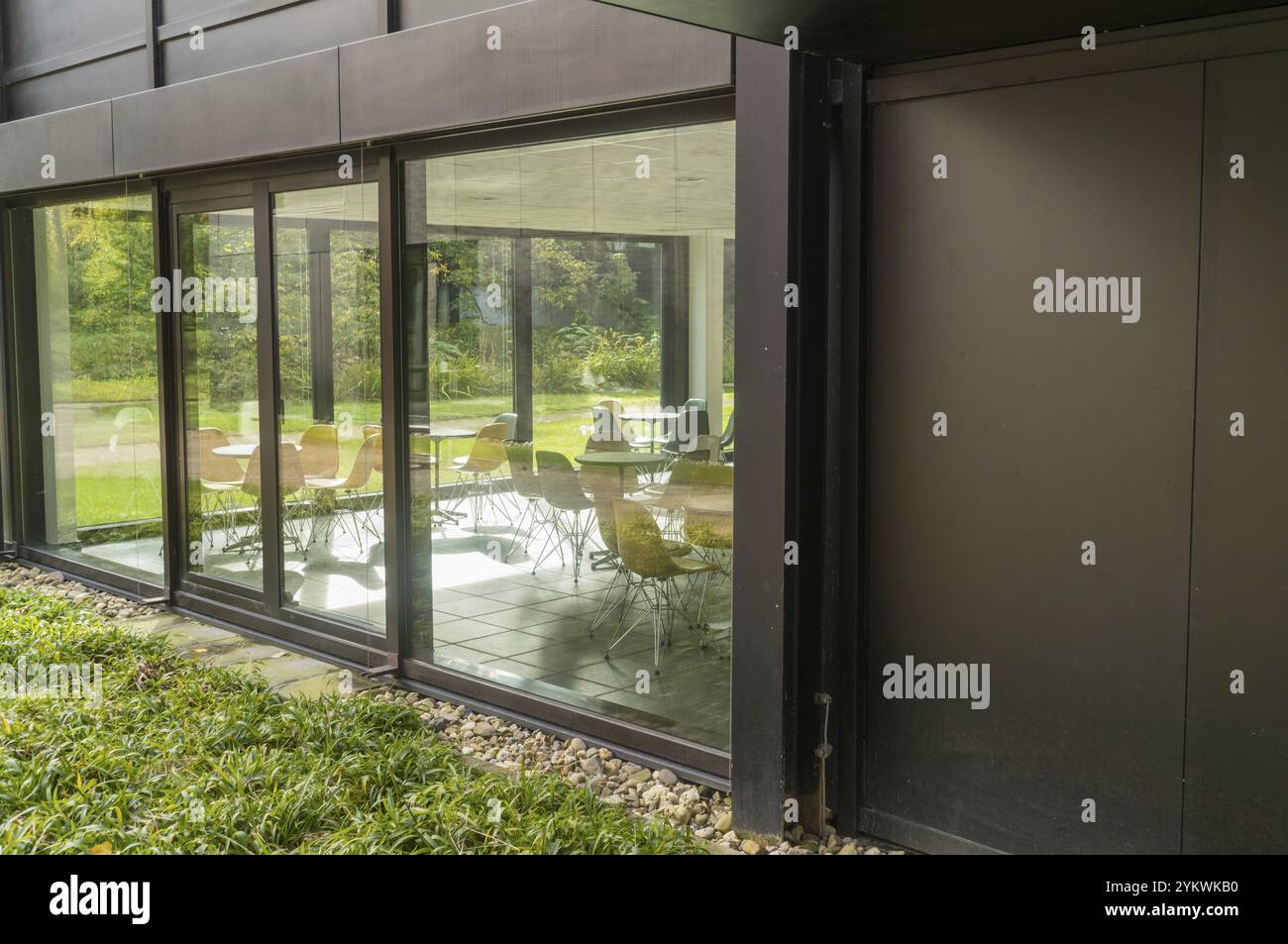 Meeting room with chairs and tables seen through the window of a modern ...