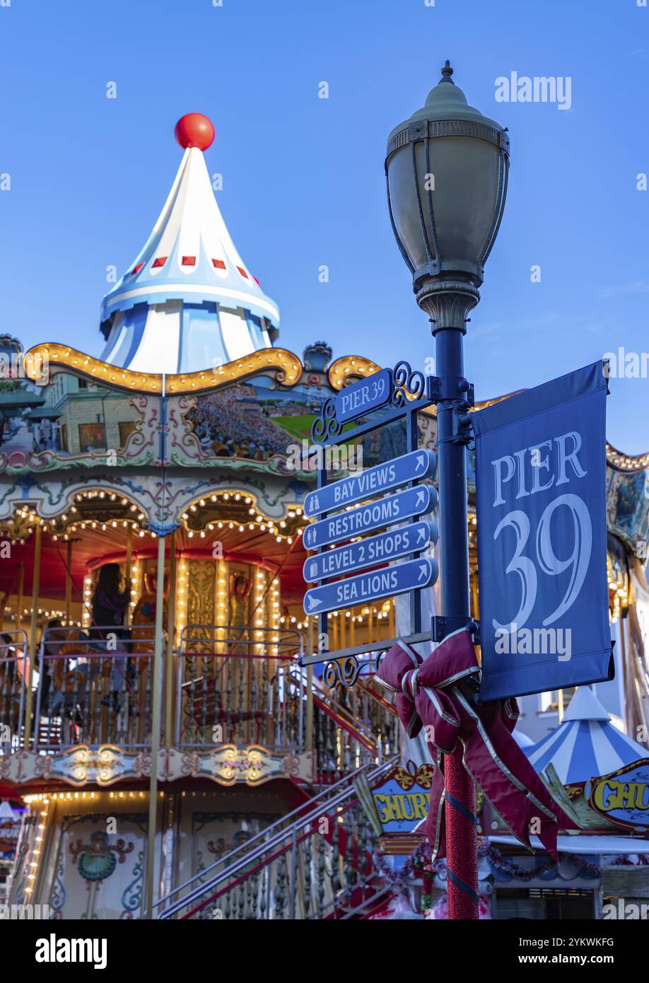 A picture of the signs of Pier 39 next to its iconic colorful carousel ...