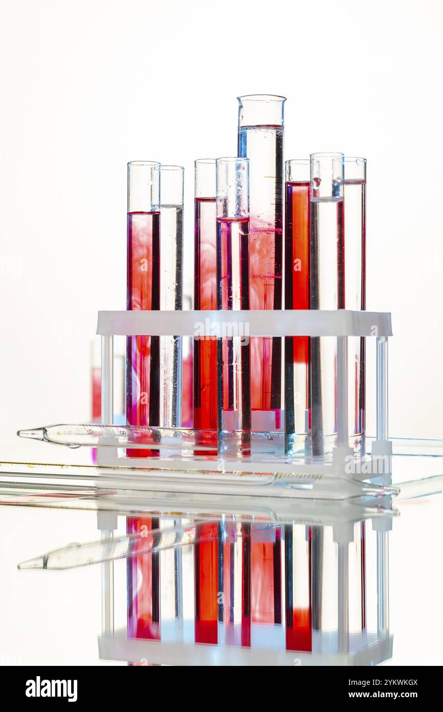Set of lab test tubes with samples of blood. Vertical shot white ...