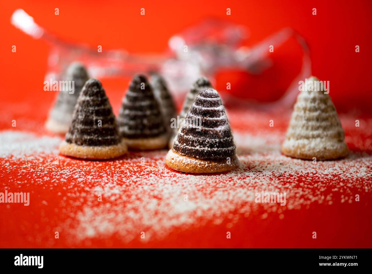 Still life with group of christmas beehive cake on snowy red background ...