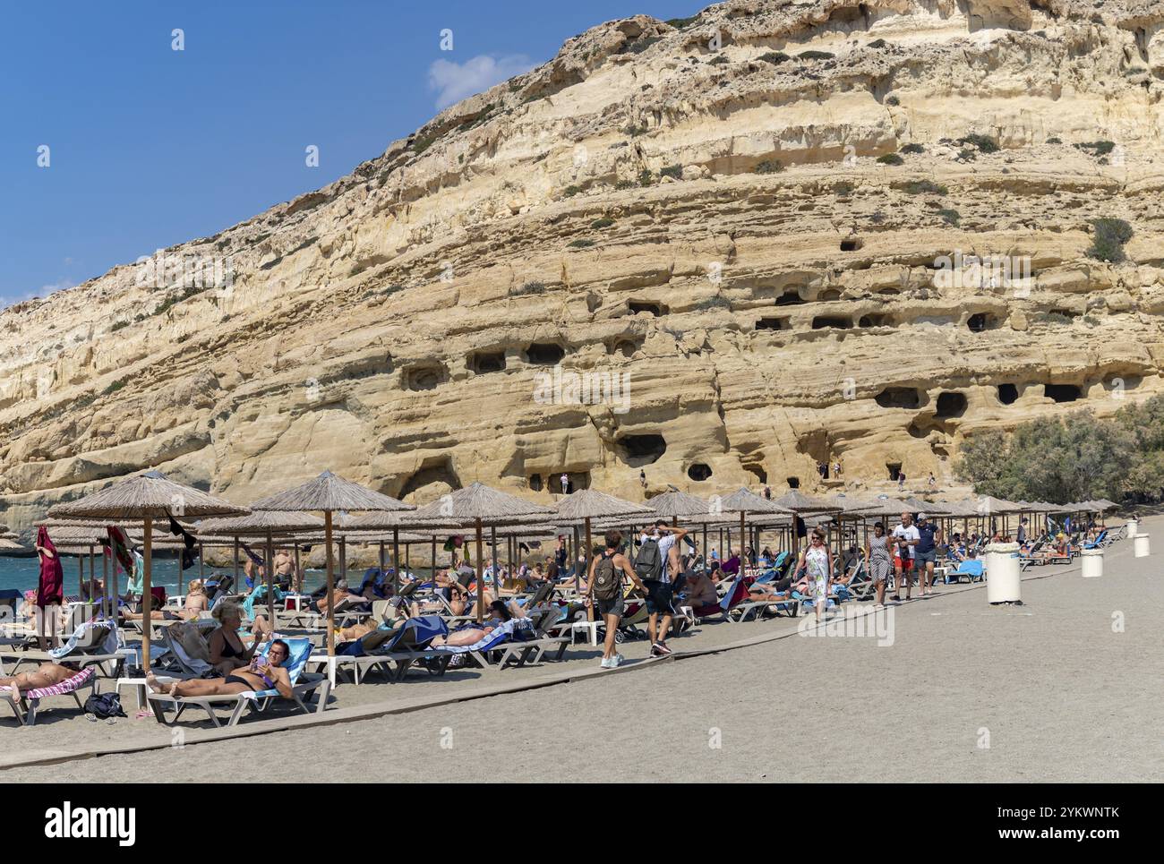 A picture of the Matala Beach, with the Matala Caves on the top Stock ...