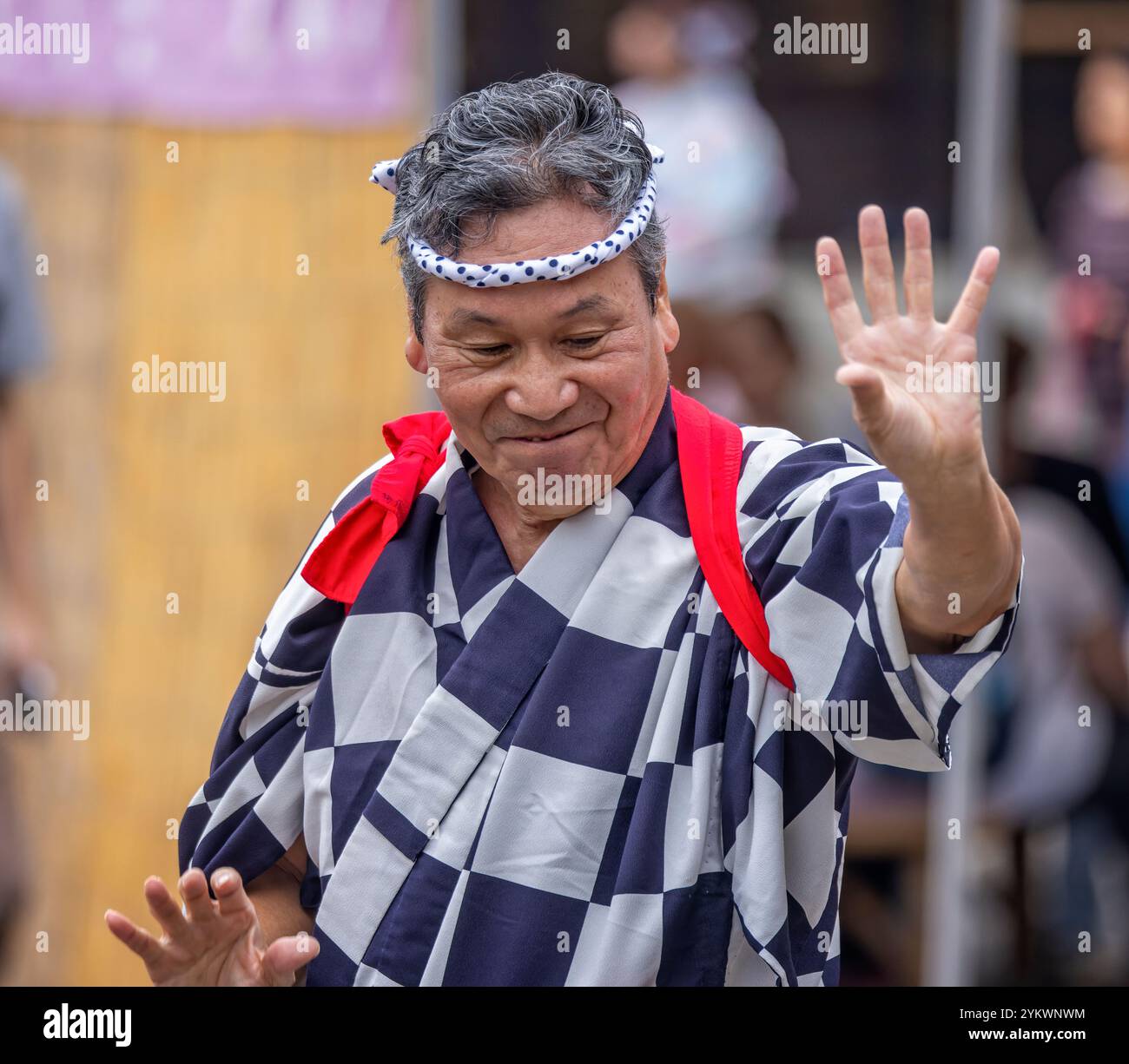 Close up of elderly Japanese man perfoming in traditional japanese ...