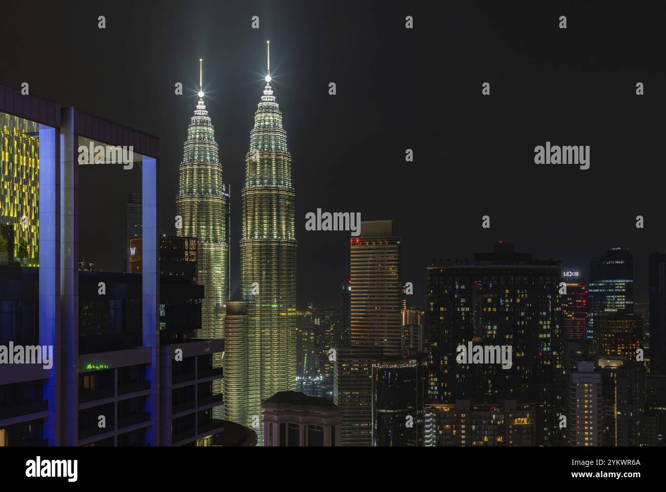 A picture of the Petronas Twin Towers at night, as seen from a nearby ...