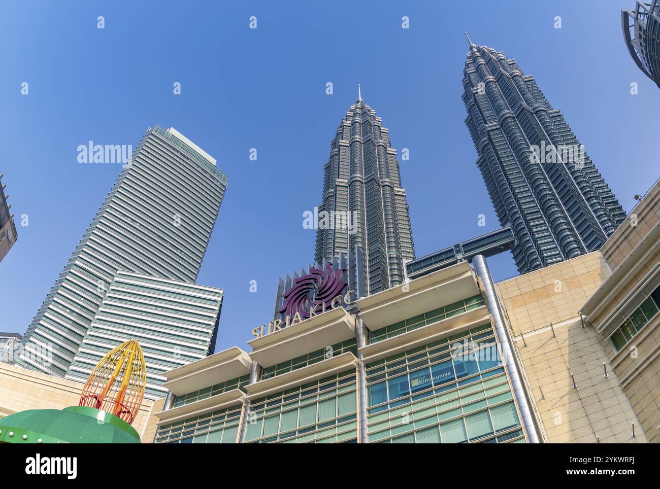 A picture of the Petronas Twin Towers rising above the Suria KLCC ...