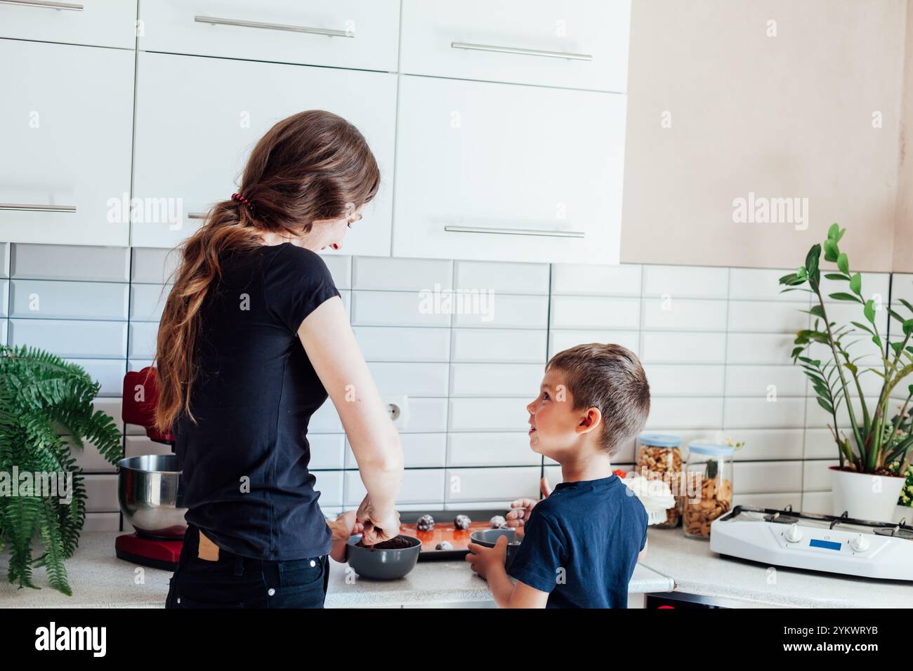 mom and son cooking food cakes in the kitchen Stock Photo - Alamy