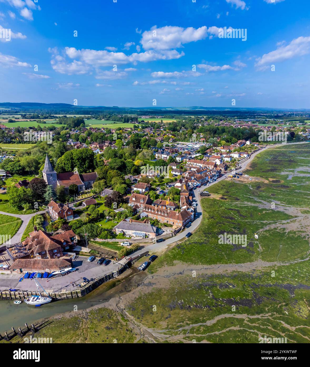 An aerial above the quayside and town of Bosham, West Sussex at low ...