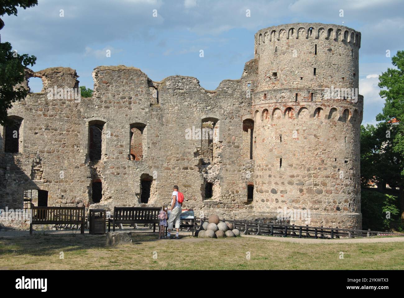 Father and daughter standing in front of Cesis Castle in Latvi Stock ...
