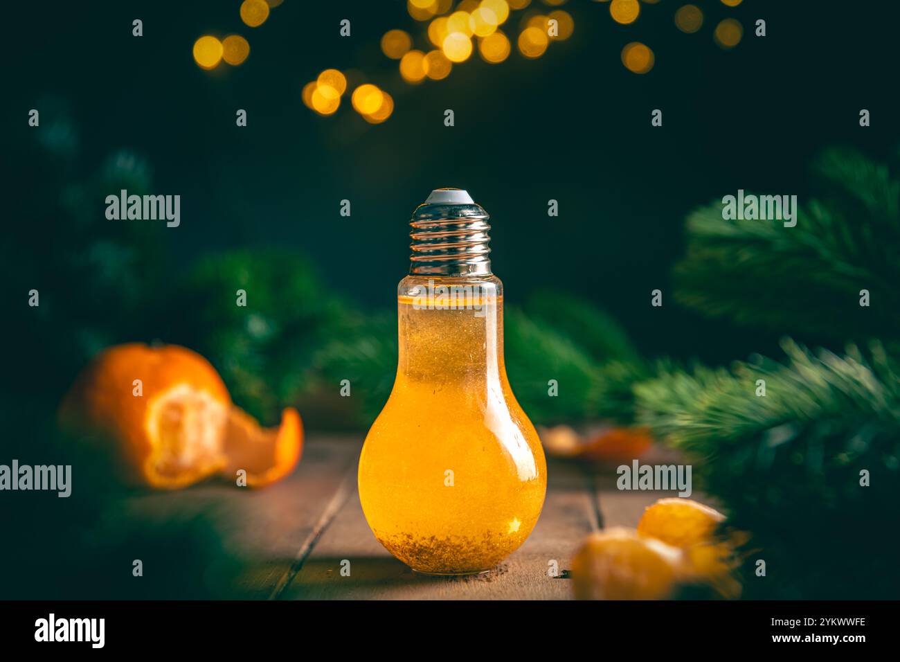 Refreshing tangerine beverage served in a lightbulb-shaped glass. Glowing warmly against a ...