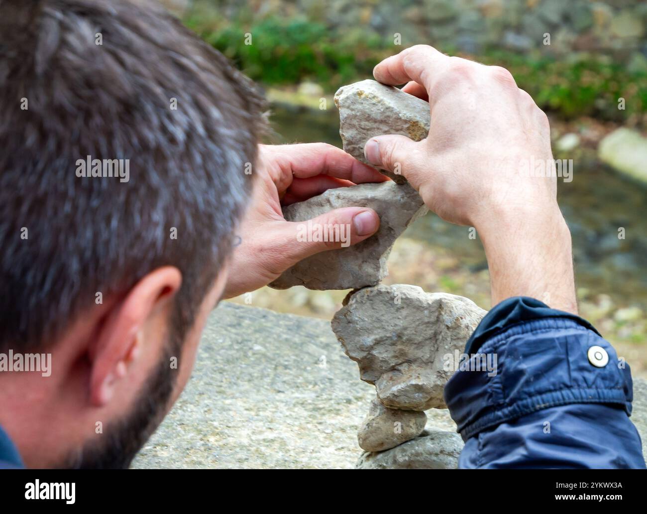 The process of installing stones to create a "balancing" pyramid ...