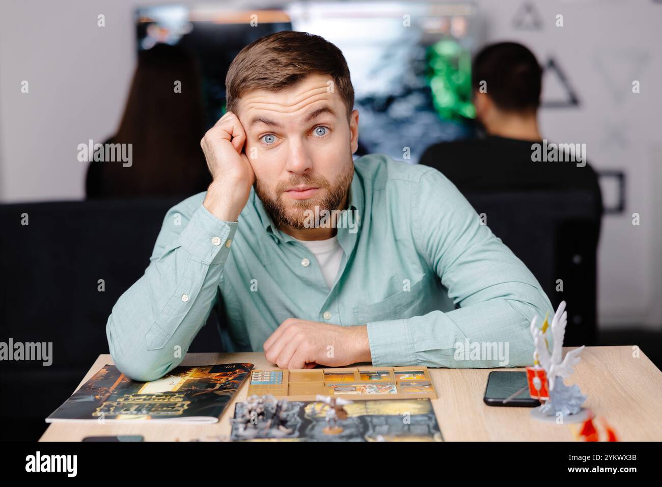Man with board game piece while practicing strategy in home alone. A ...