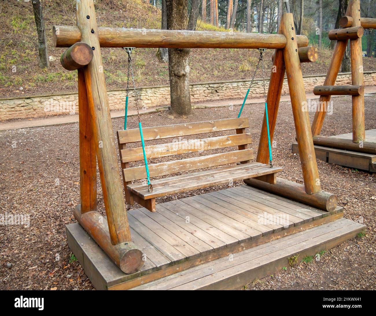 Wooden park swing made of logs Stock Photo - Alamy