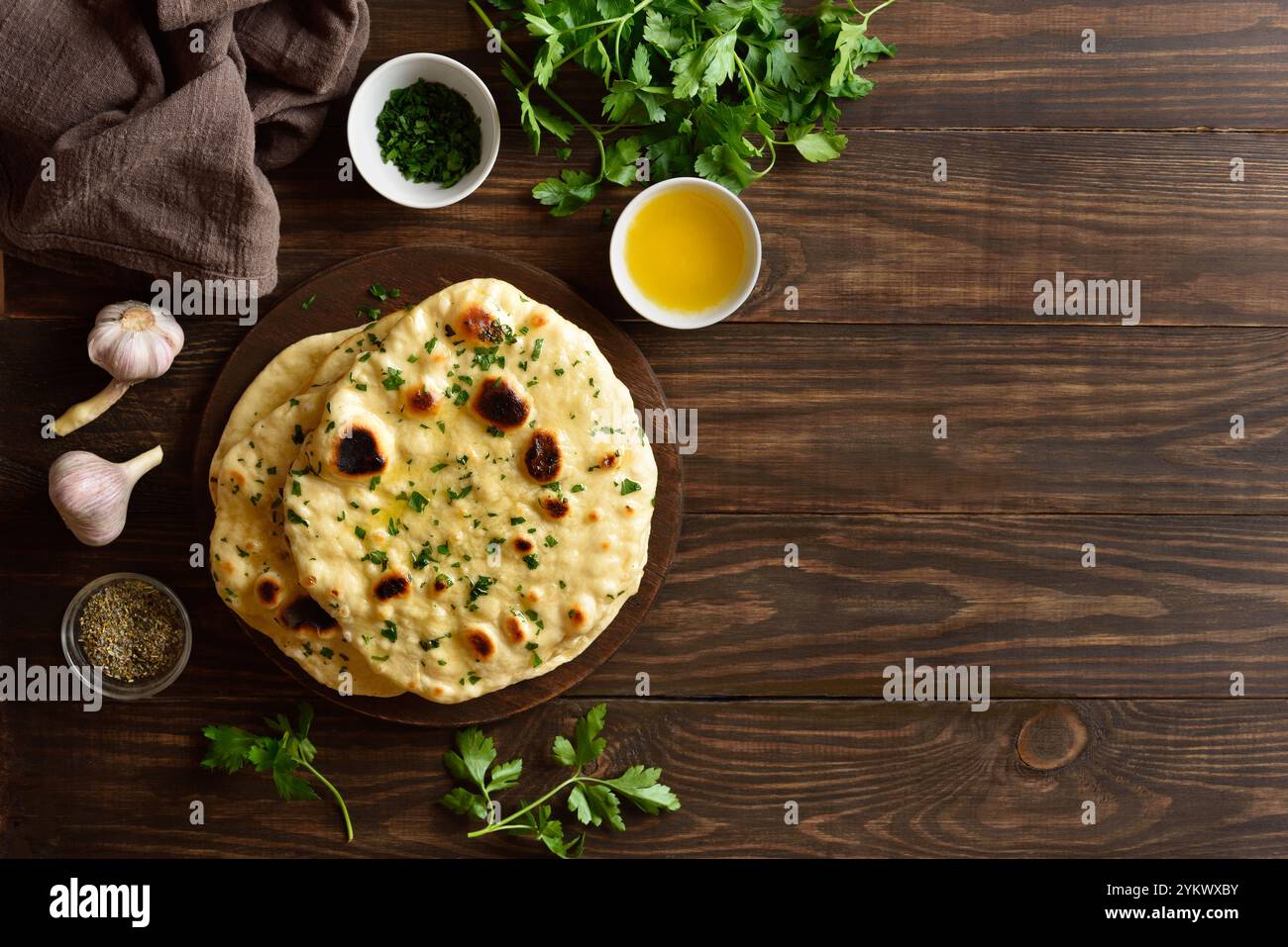 Homemade indian naan bread with garlic butter on wooden background with ...
